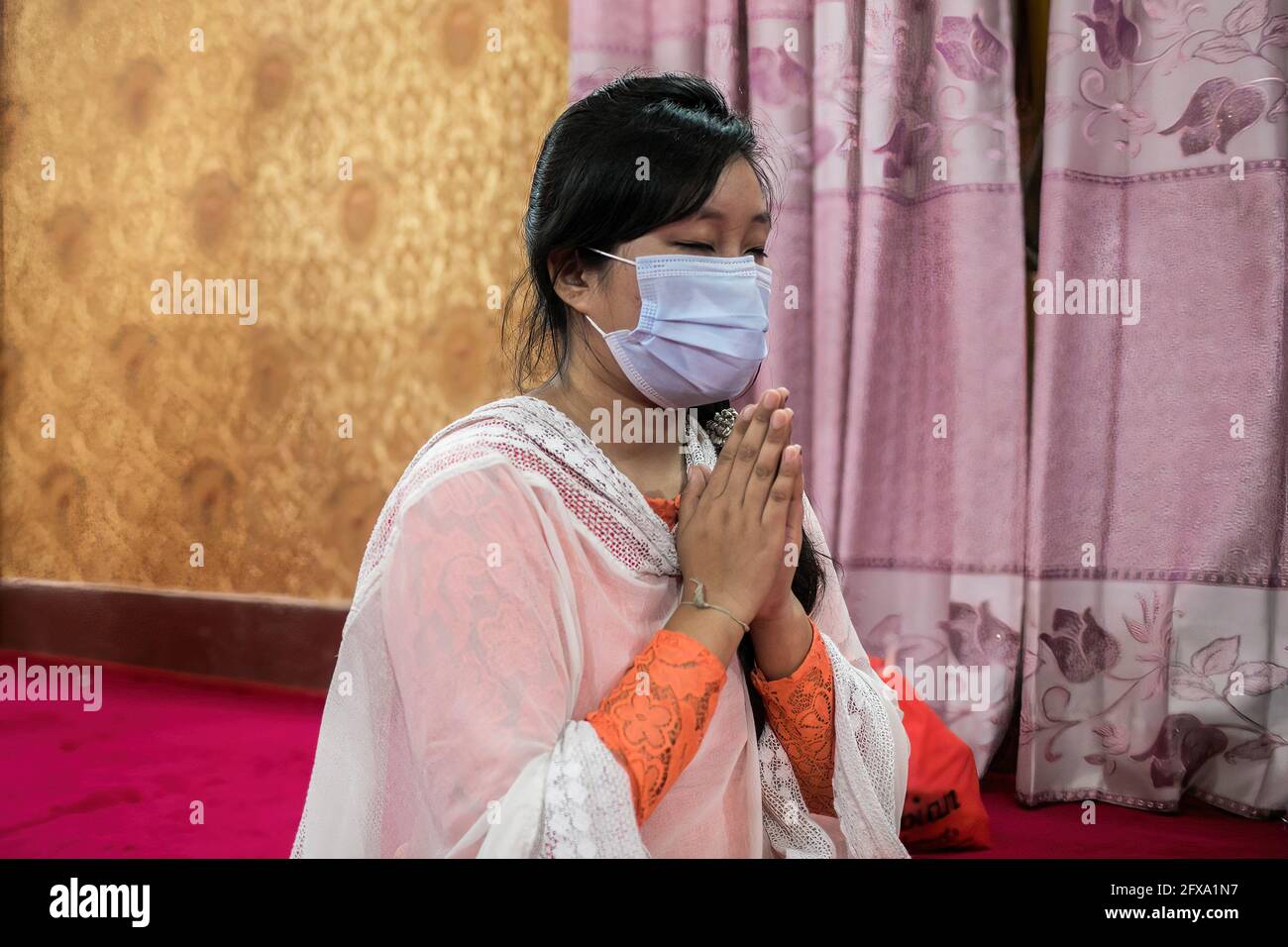 Buddhist devotee seen praying in front of the statue of Lord Buddha ...