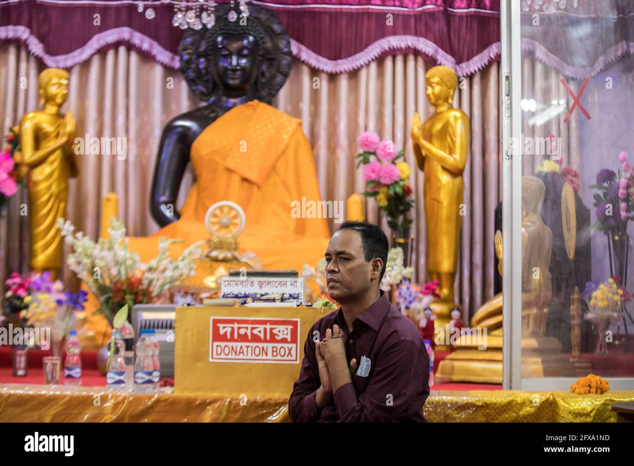 A Buddhist devotee seen praying at a temple during the celebrations ...