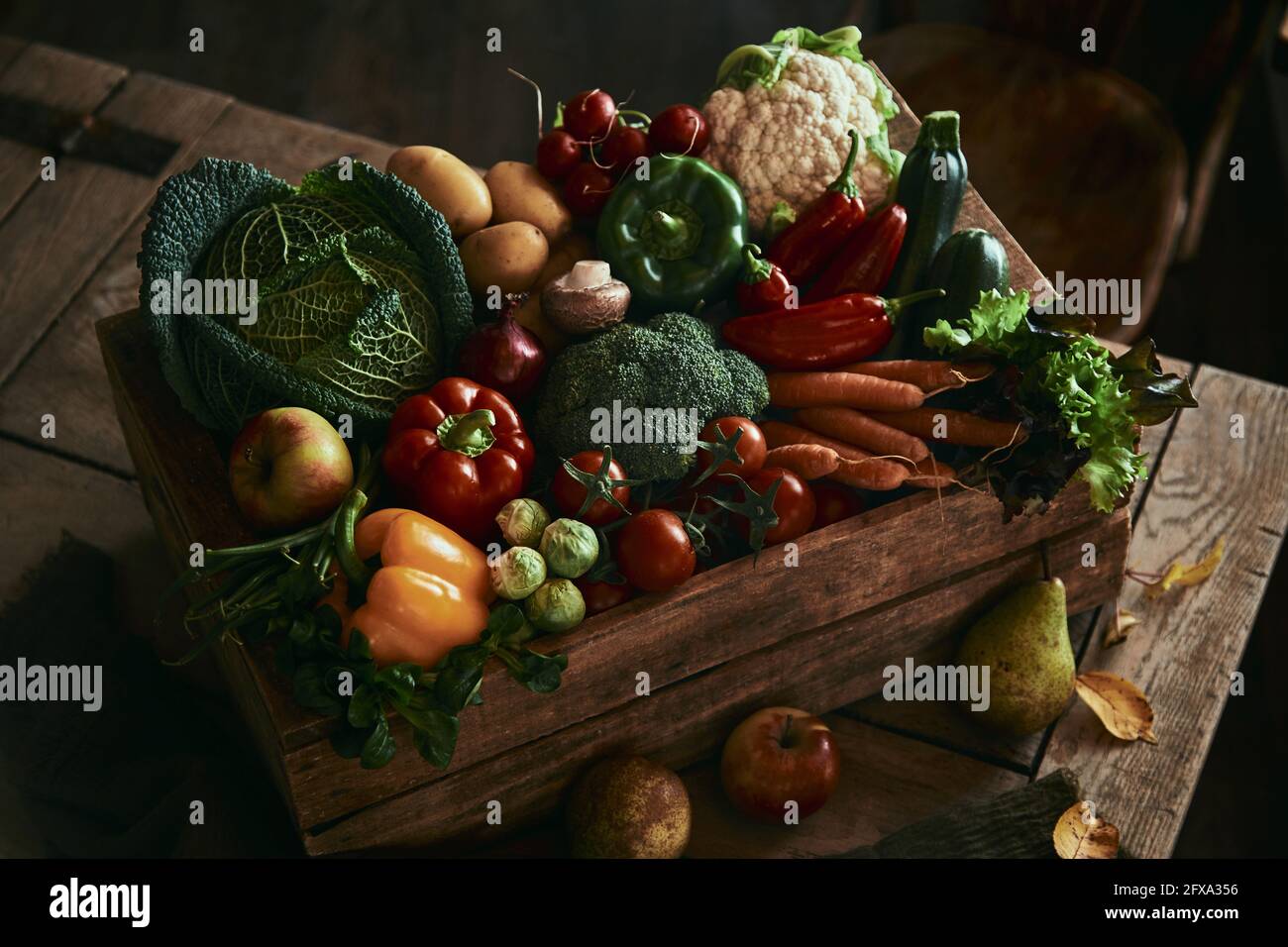 From above box with various fresh vegetables placed on timber table in ...