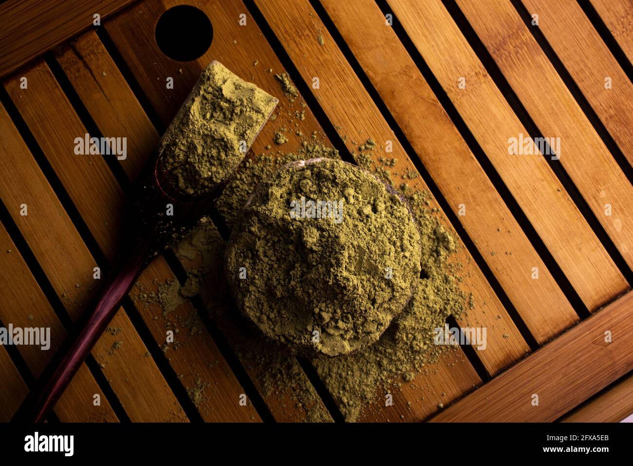 matcha, green tea in clay pot and a wooden spatula sprinkles tea on ...