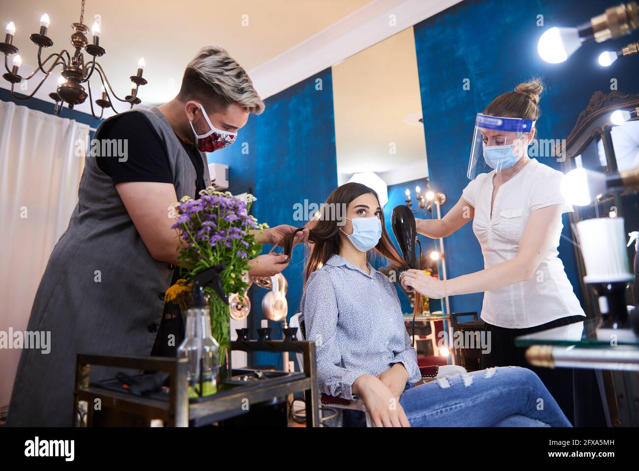 Hairstylists making hair for a customer Stock Photo - Alamy