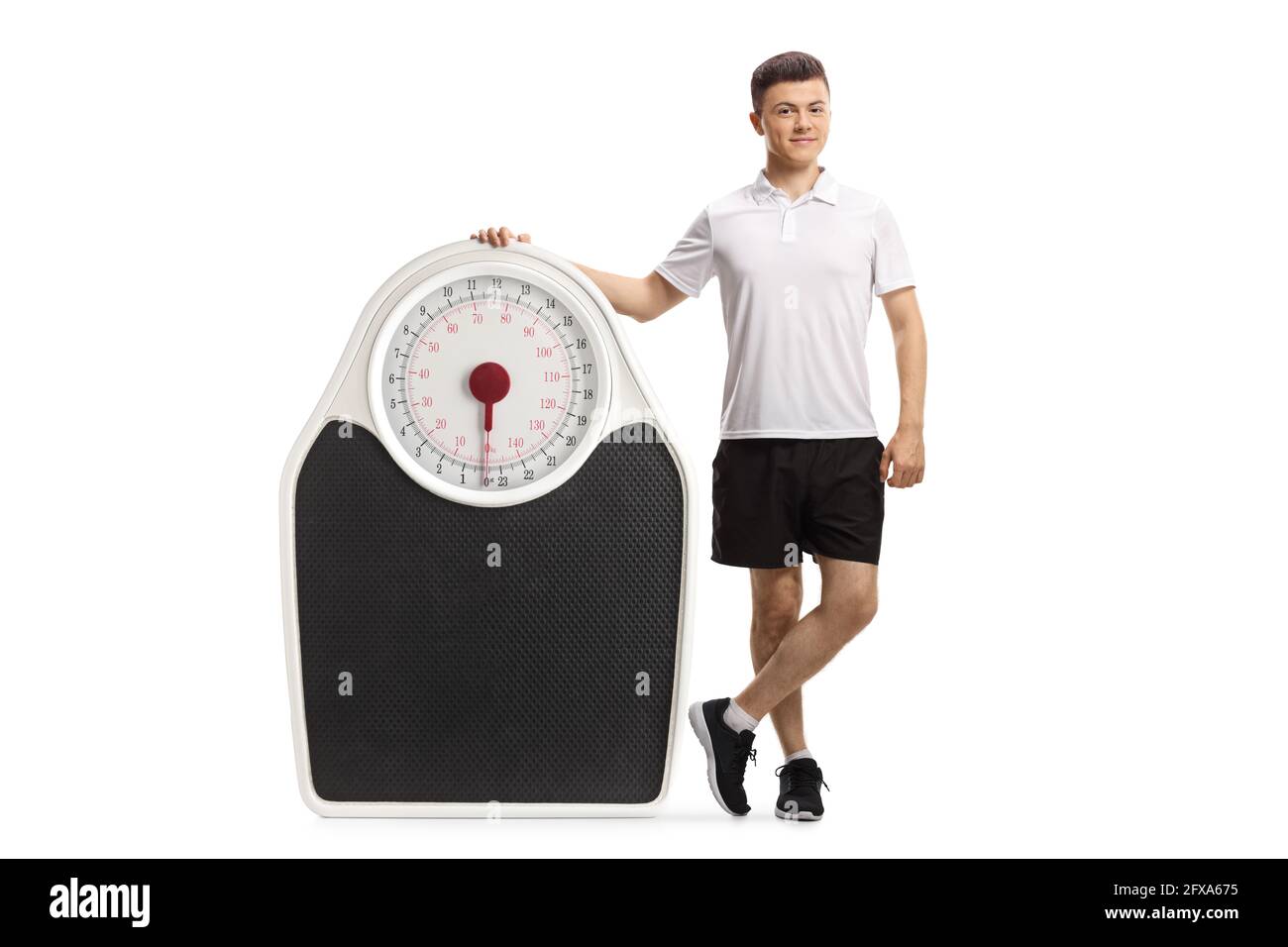 Full length portrait of a young man in sportswear posing next to a big ...