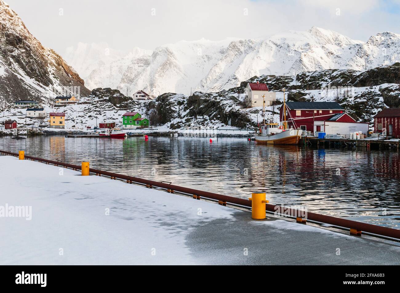 Harbor with boats in front of snow covered mountains Stock Photo - Alamy