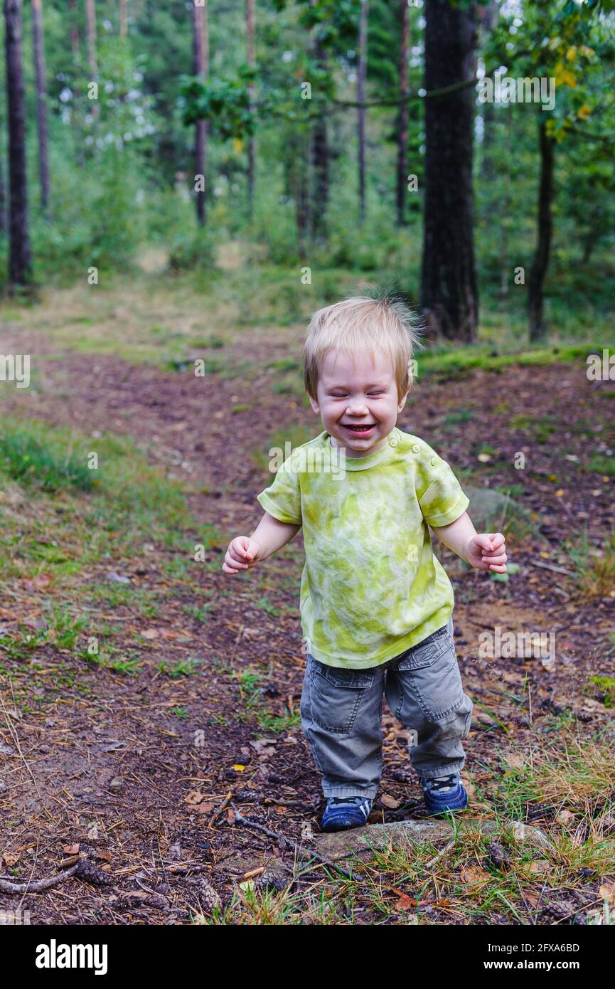 Happy boy child in forest Stock Photo - Alamy