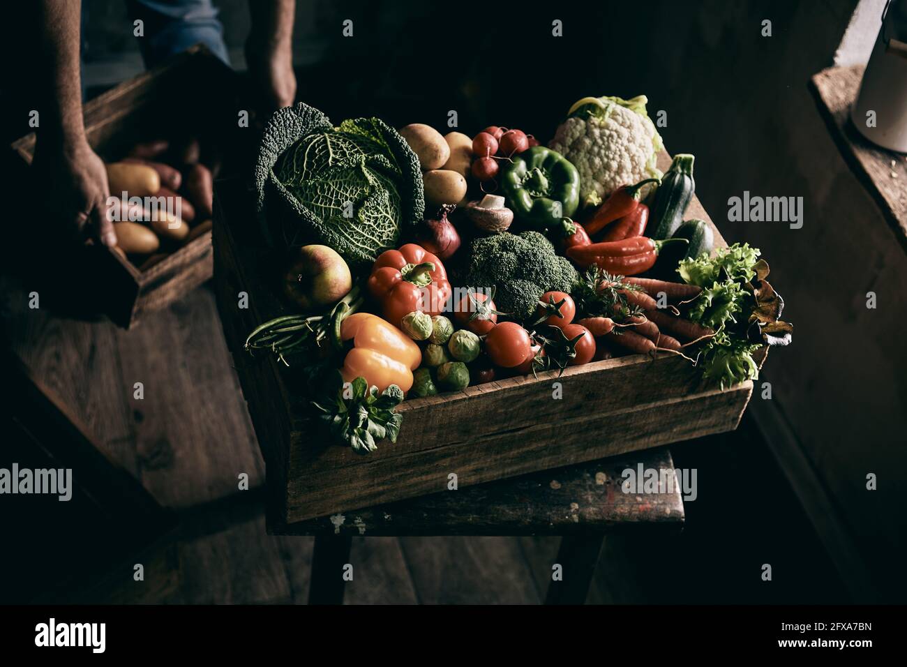 From above container with assorted fresh vegetables placed on stool ...