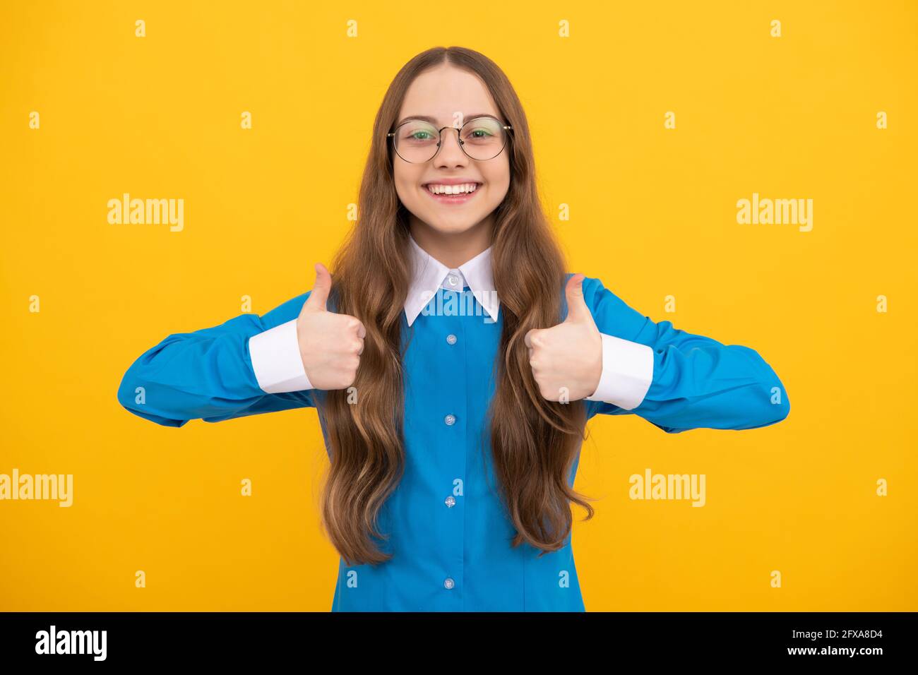 Get education, get satisfaction. Happy teen girl give thumbs ups ...