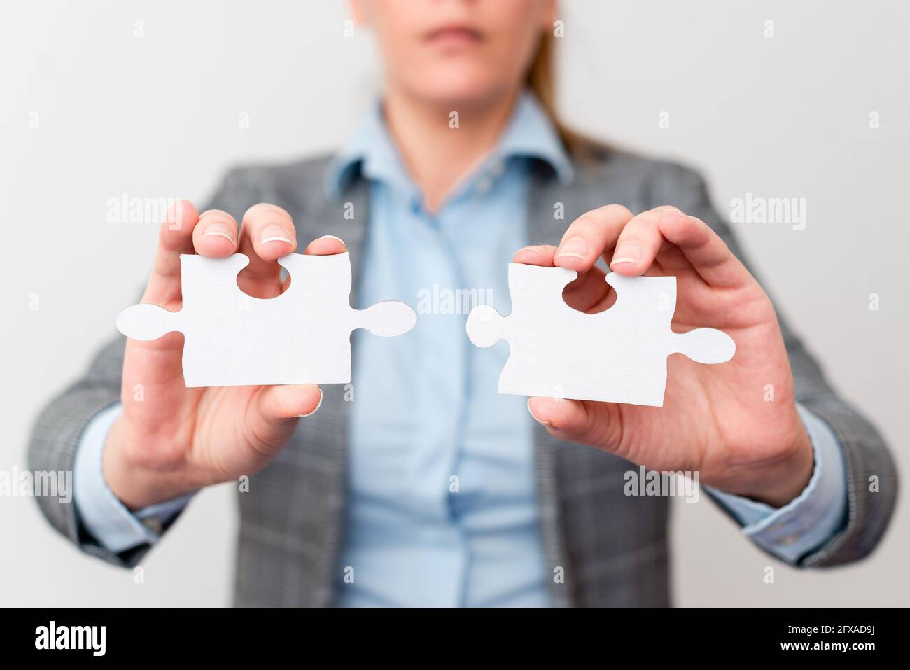 Welldressed Business Woman Holding Two Pieces Of Jigsaw Puzzle ...
