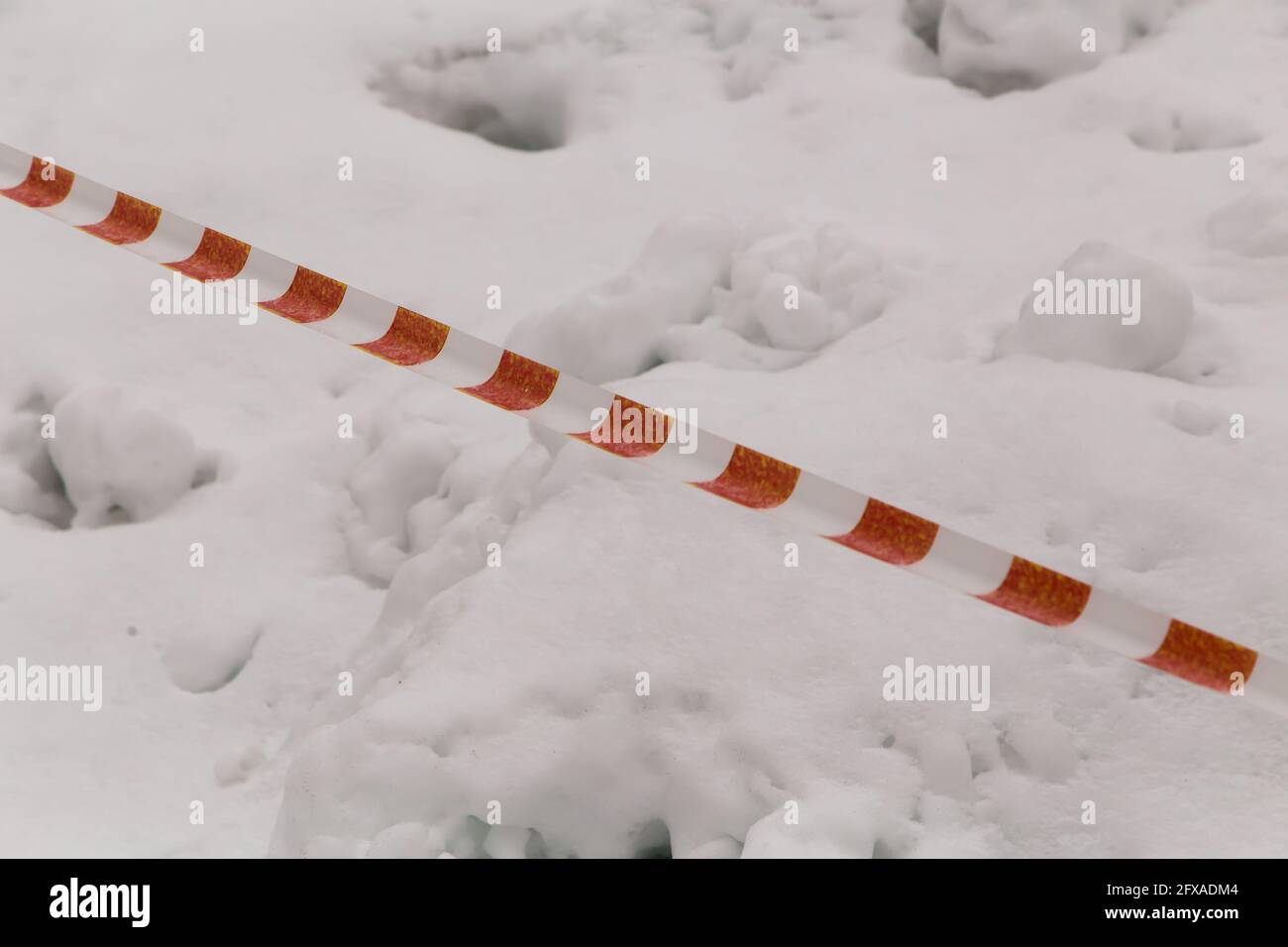 The signal striped white-red tape is stretched diagonally. The passage ...