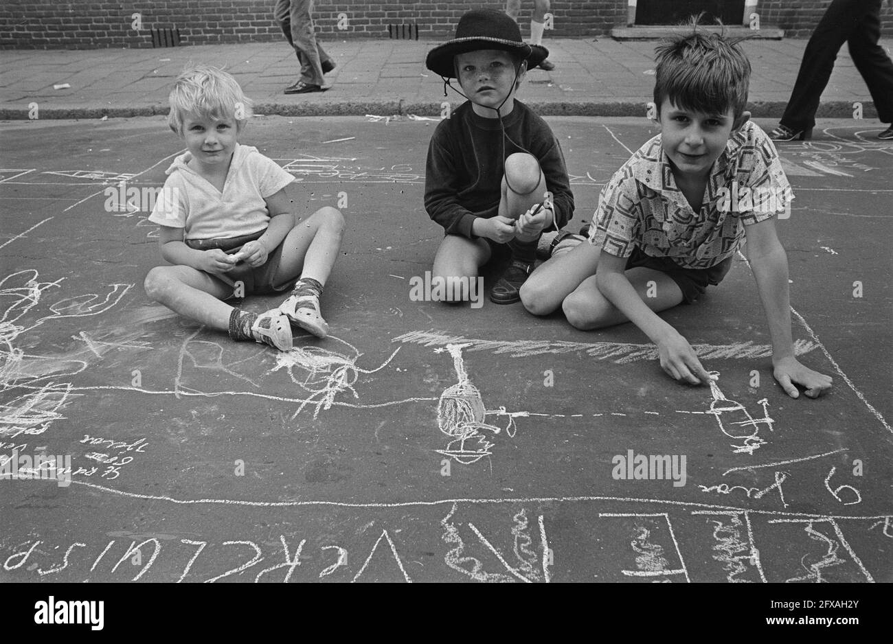Three boys drawing in the street, July 6, 1970, children, street ...