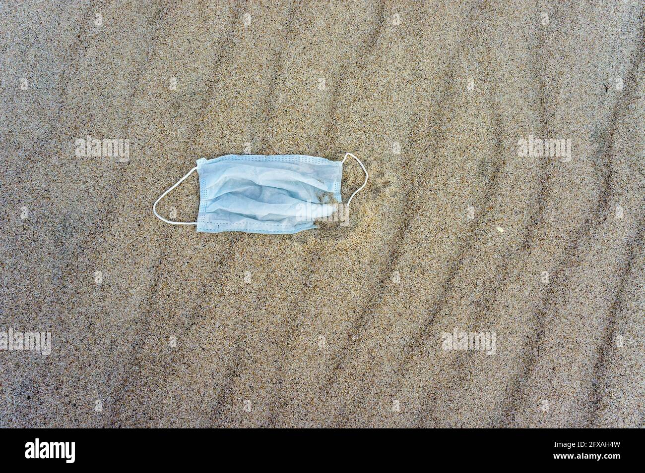 Abandoned used mask. The mask on the sand. The mask is lying on the sea ...