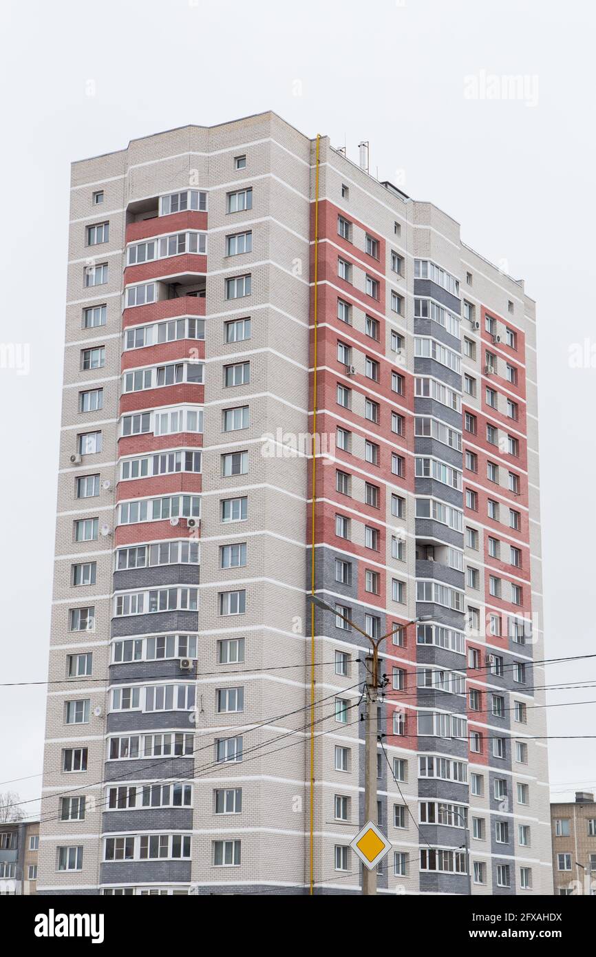 High-rise new building with gray and red balconies. Modern new ...