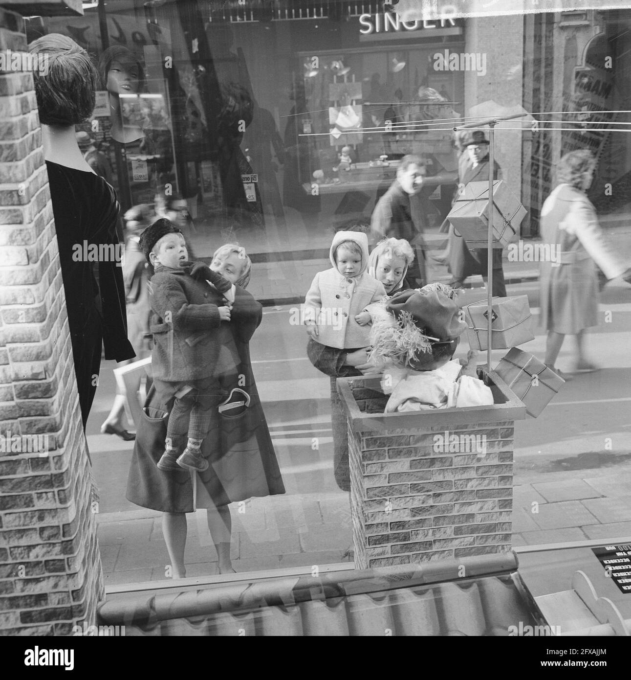 Crowds in Amsterdam's shopping streets. Window display with thick roof ...