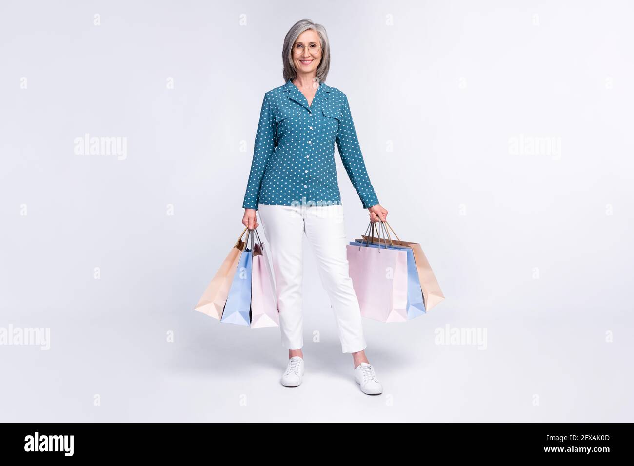 Full length body size view of attractive cheerful woman carrying new ...