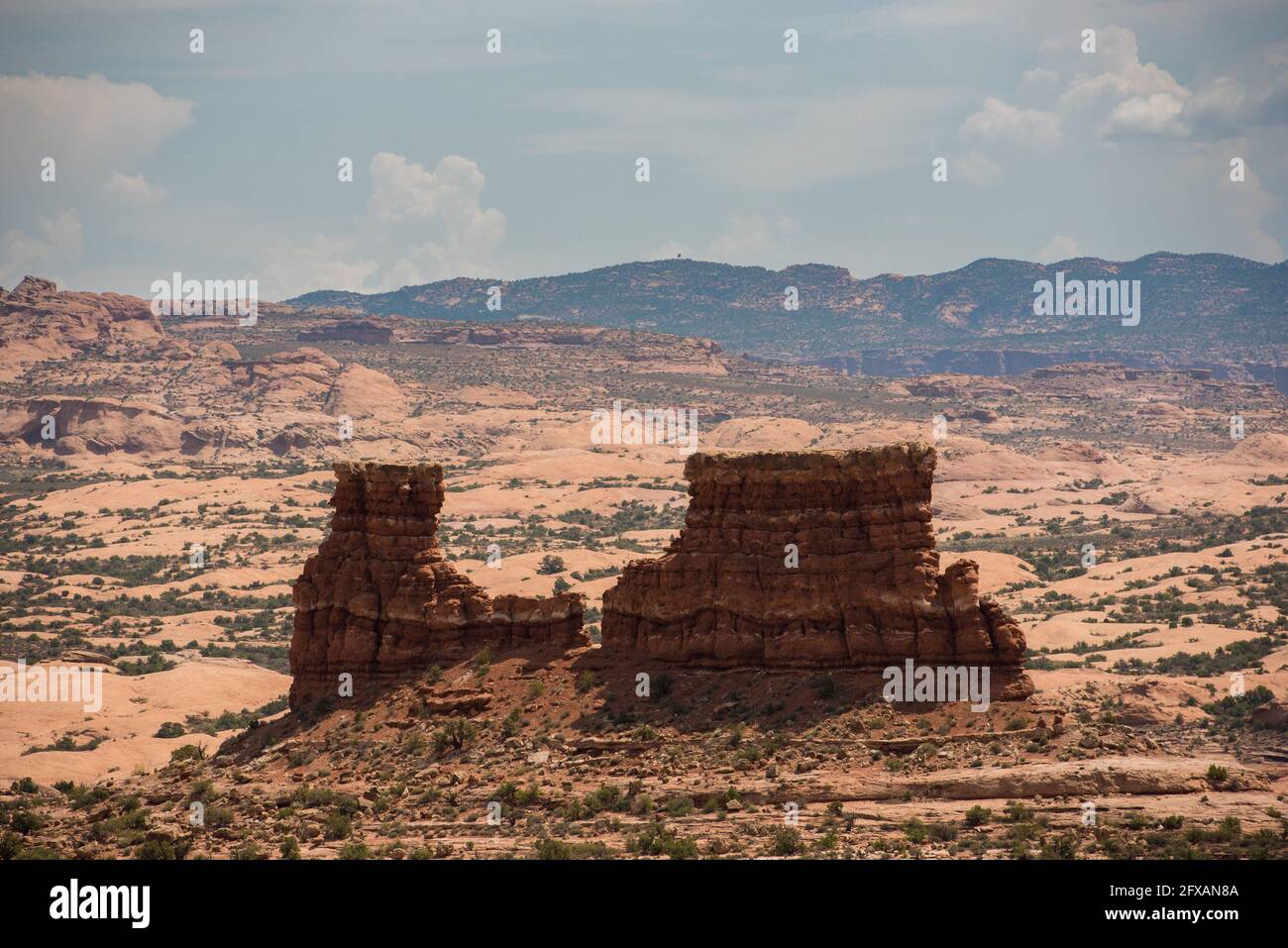 Southwest textures of mesa with mountains in background Stock Photo - Alamy