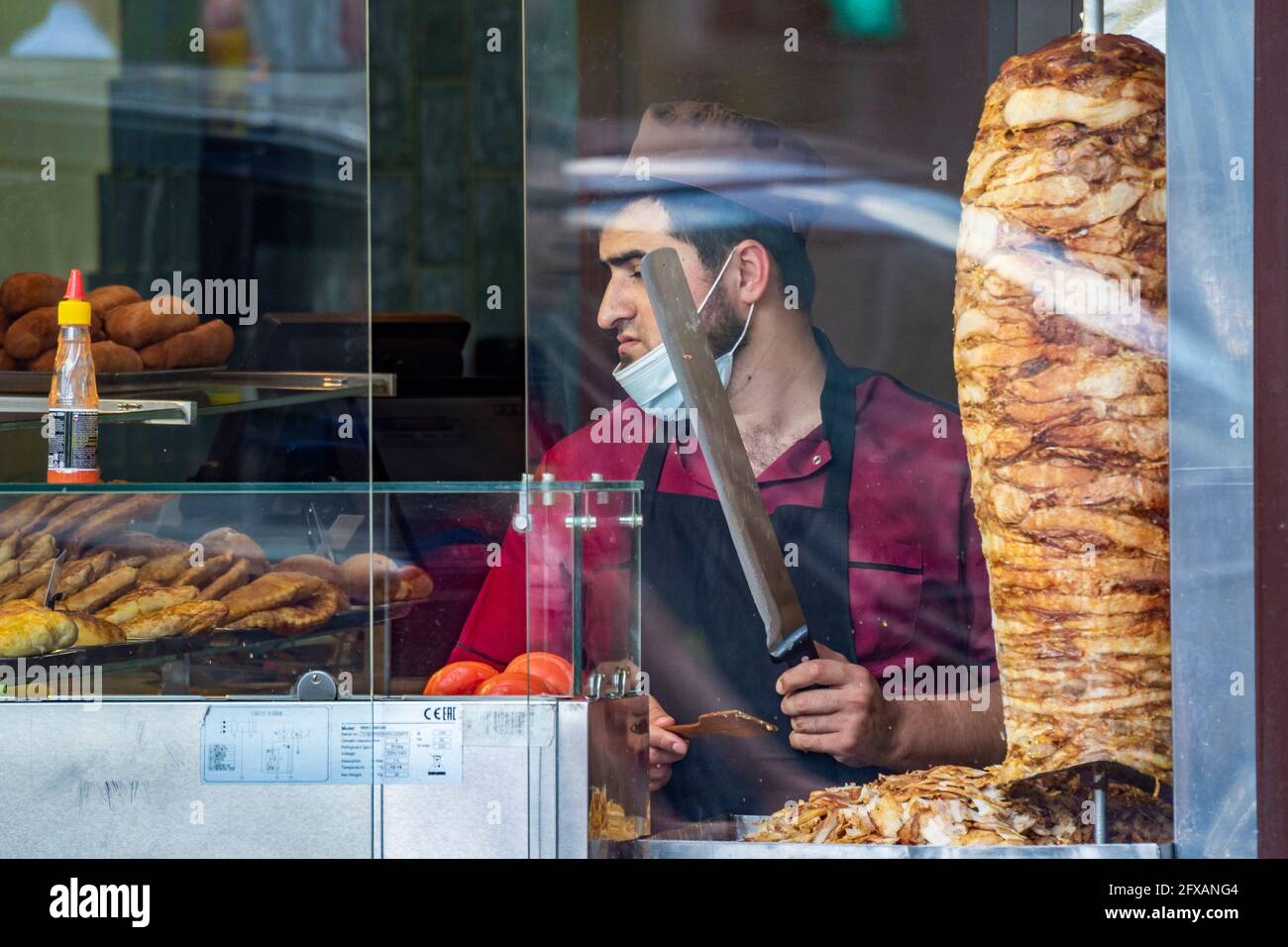 Russia, Moscow. An employee cooks a shawarma at the fast food ...