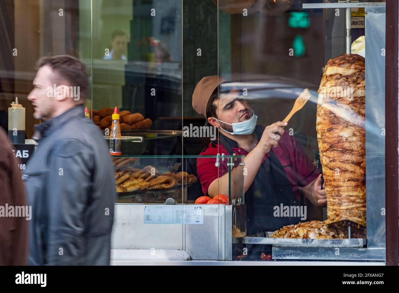 Russia, Moscow. An employee cooks a shawarma at the fast food ...