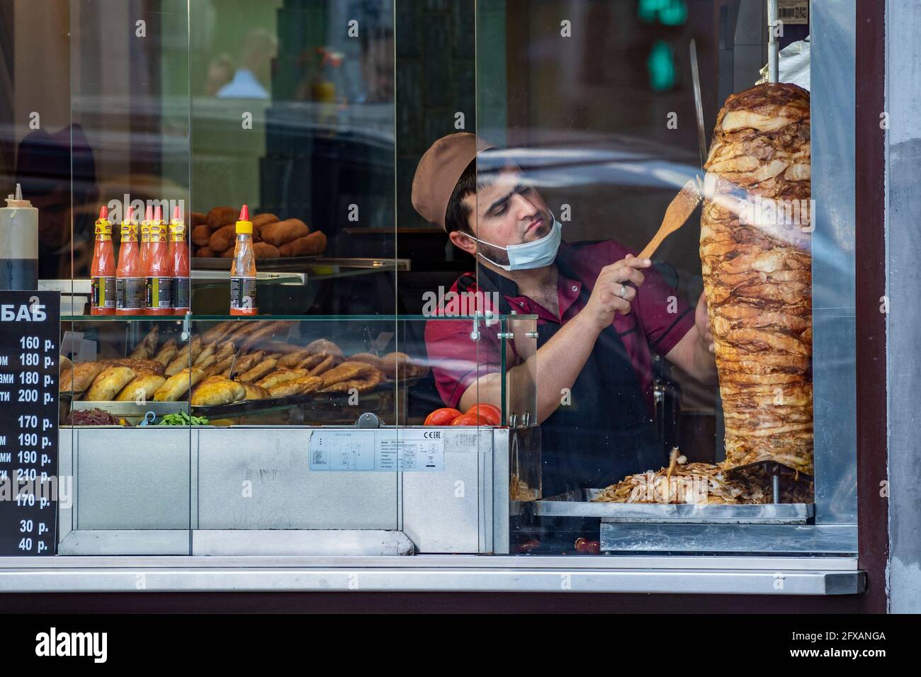 Russia, Moscow. An employee cooks a shawarma at the fast food ...