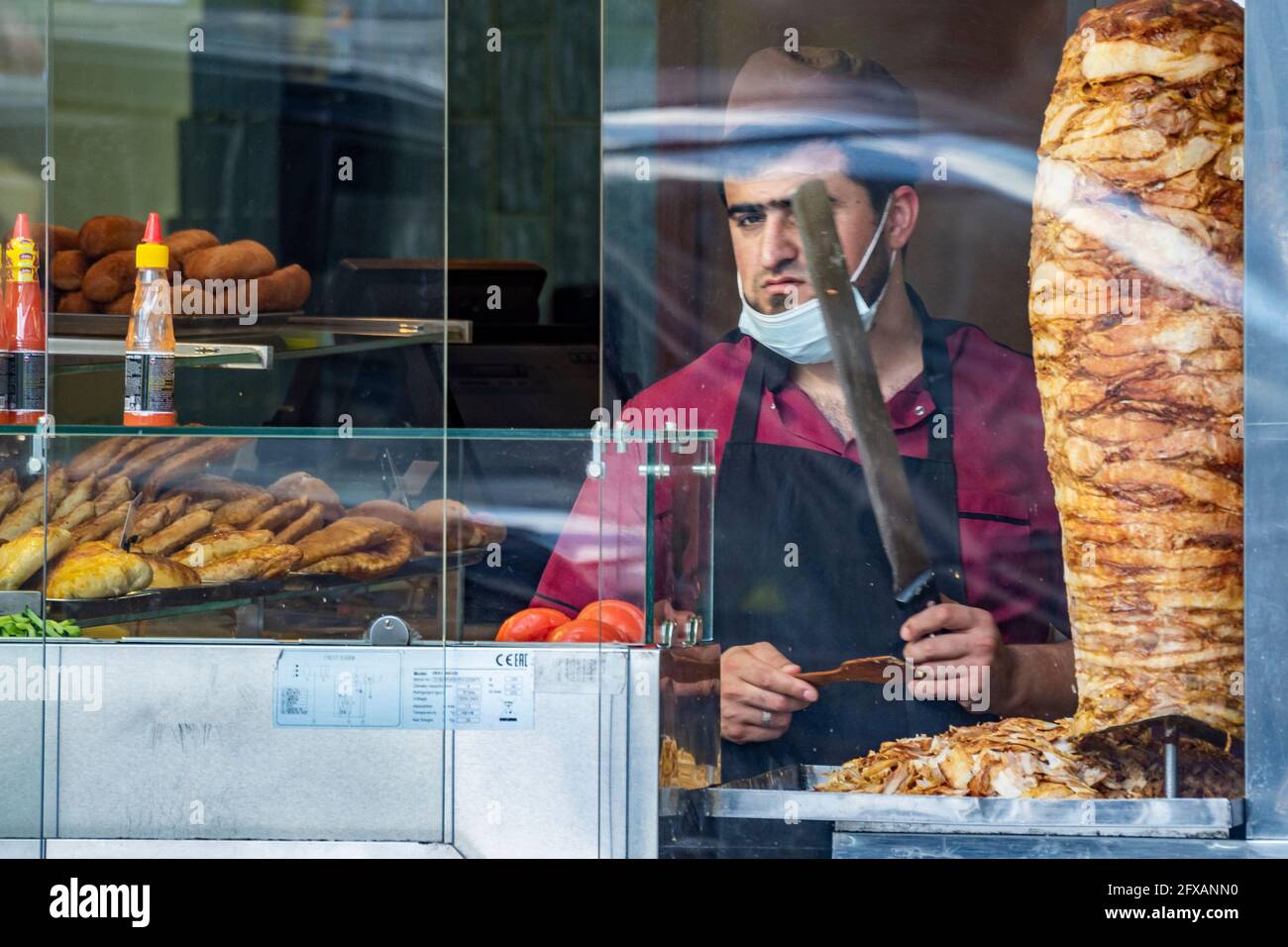 Russia, Moscow. An employee cooks a shawarma at the fast food ...