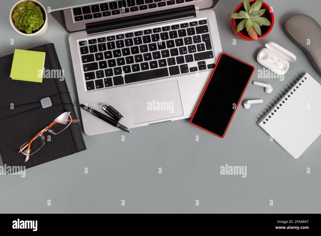 Office desk with modern gadgets on a grey desk top view Stock Photo - Alamy