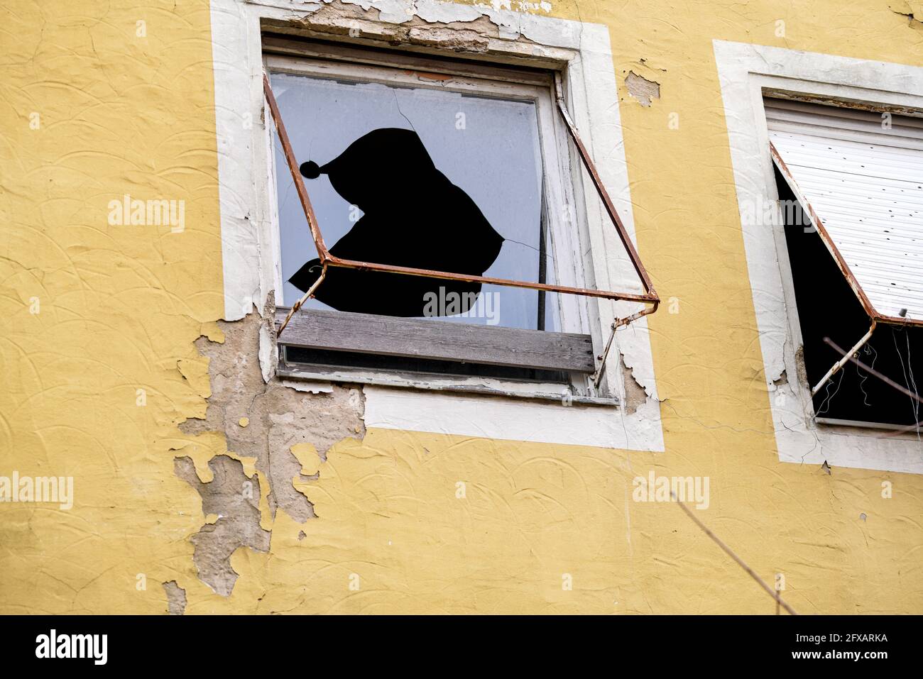 Broken, smashed window glass on an uninhabited building in Bavaria ...