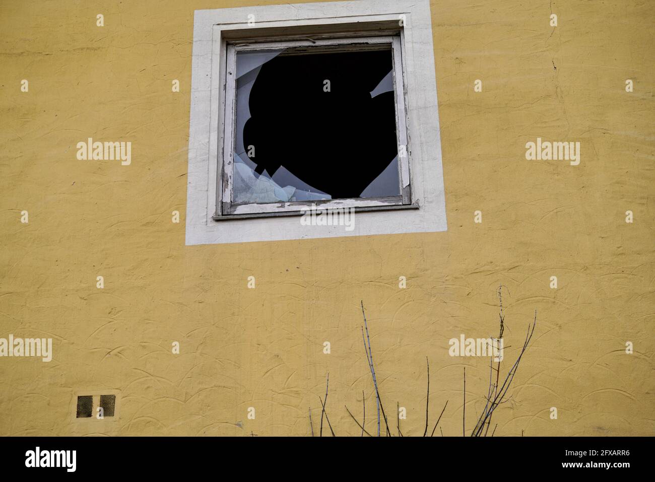 Broken, smashed window glass on an uninhabited building in Bavaria ...