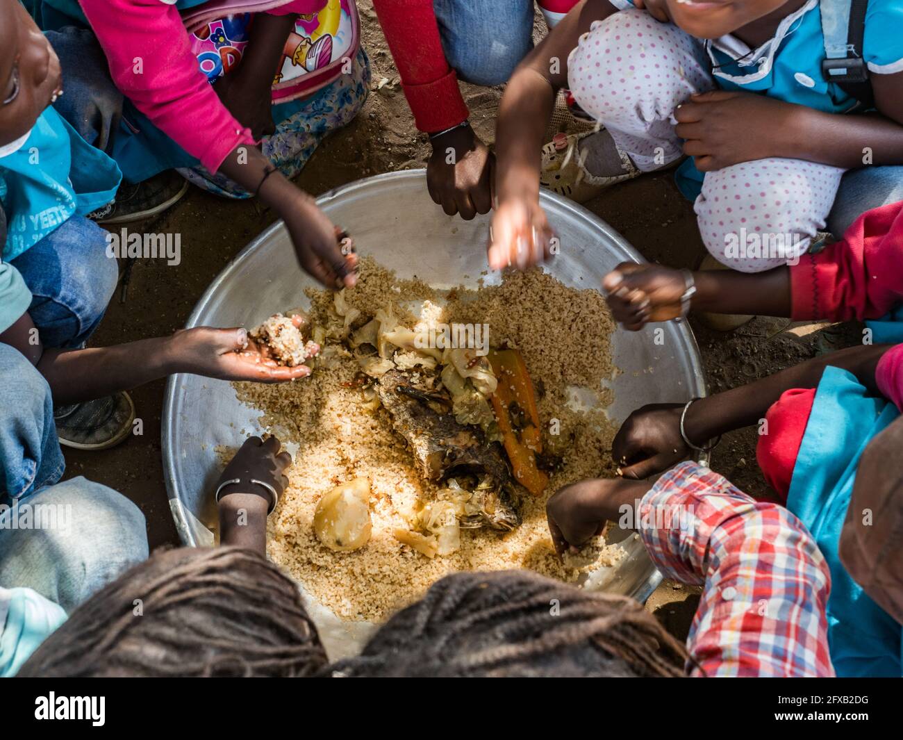 Senegalese children eat at school together in a traditional way ...