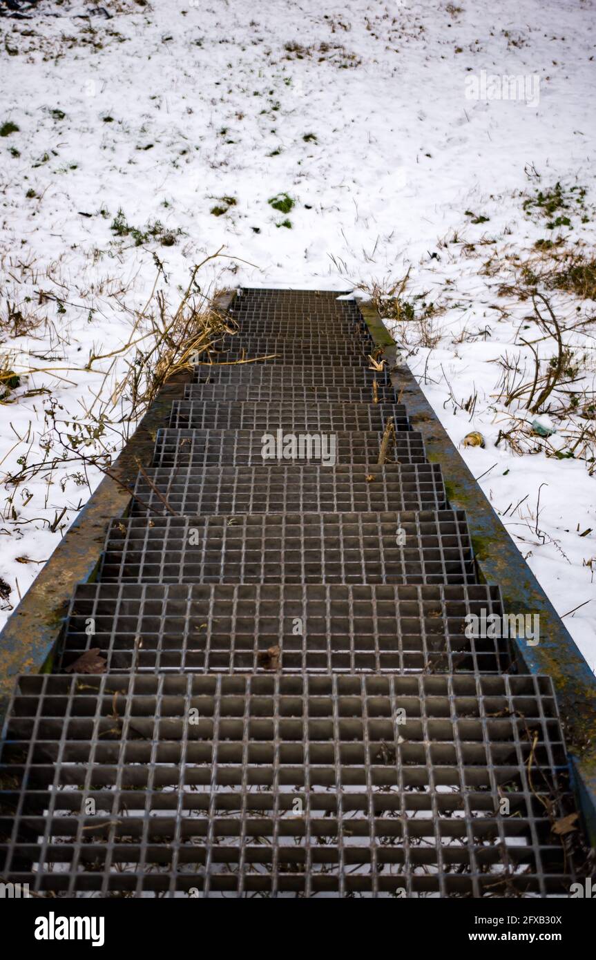 Metal grid stairs and snow Stock Photo - Alamy