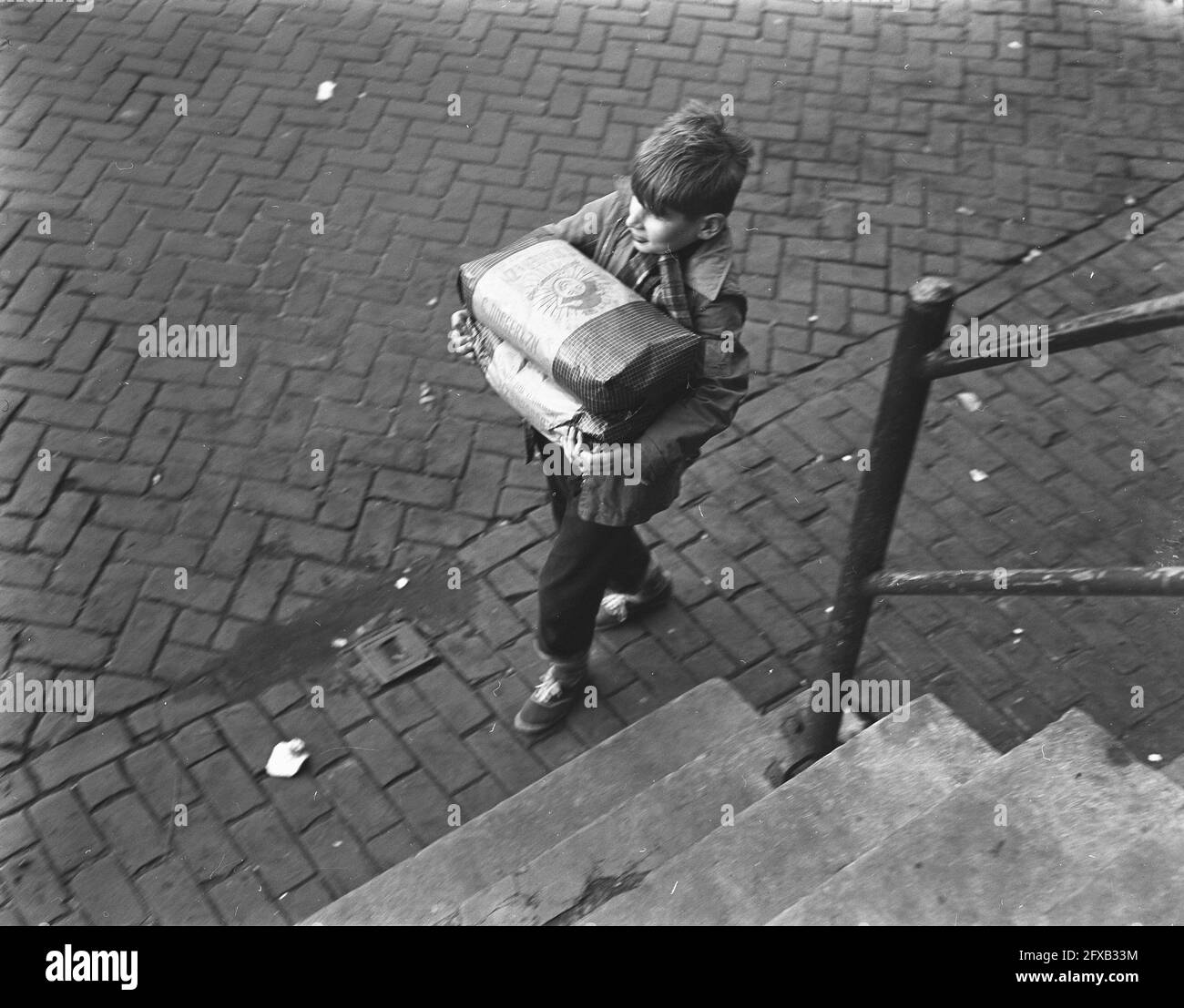Boys drag coal packets hi-res stock photography and images - Alamy