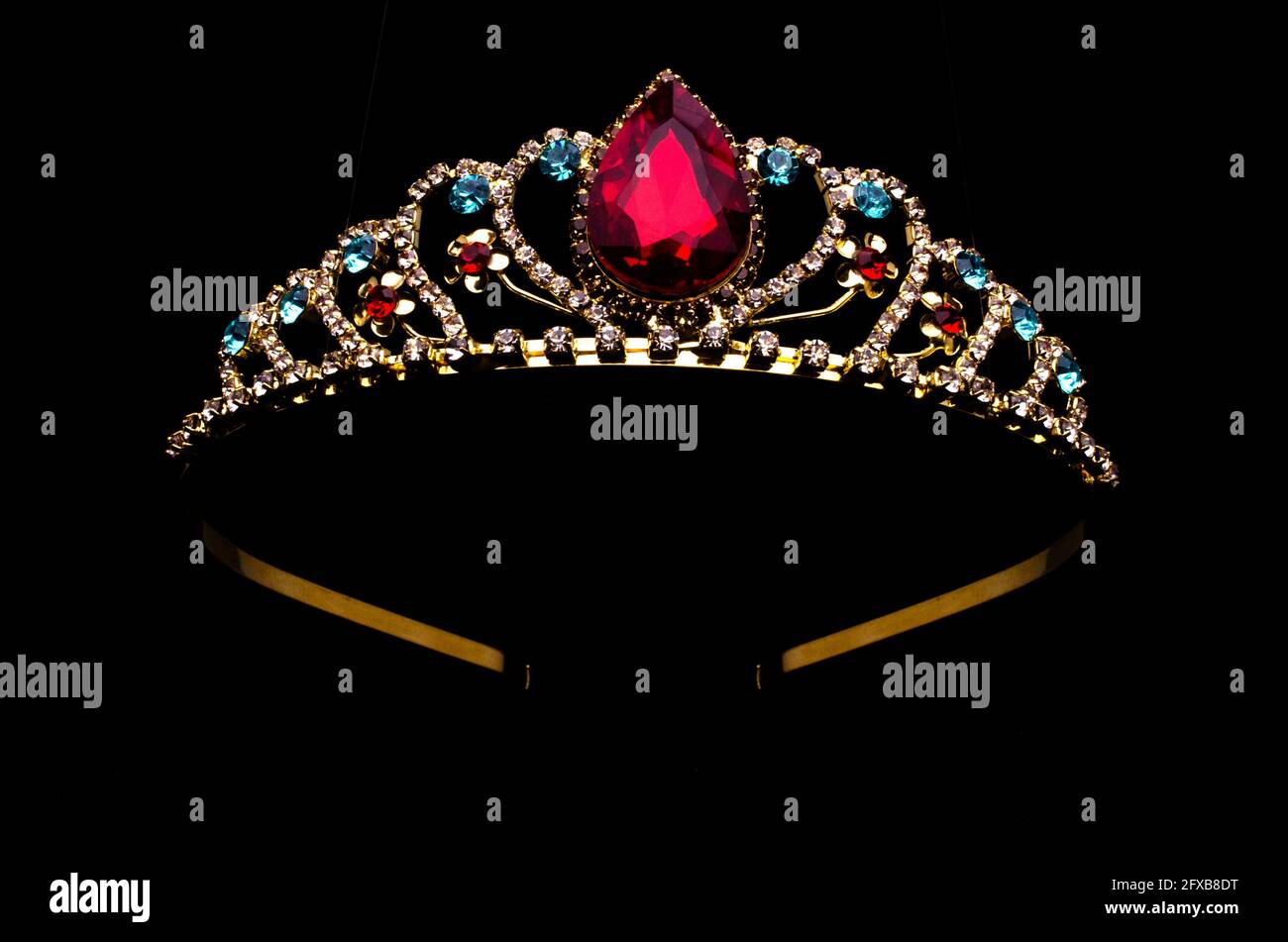gold crown with red ruby stone isolated on black Stock Photo - Alamy