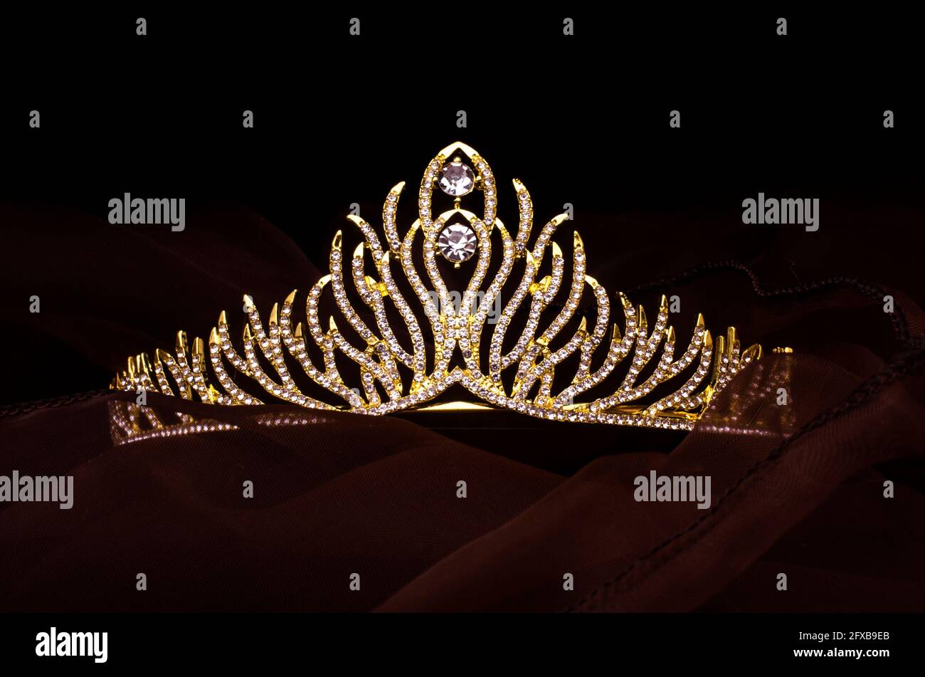 gold diadem with diamonds isolated on the fabric Stock Photo - Alamy