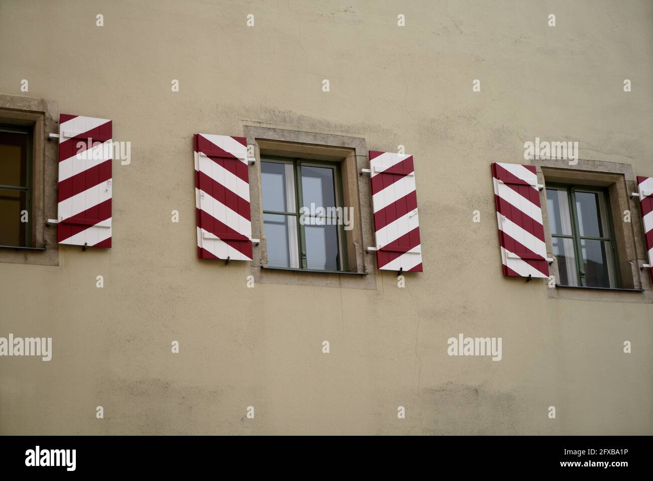 Windows with white and red striped blinds Stock Photo - Alamy