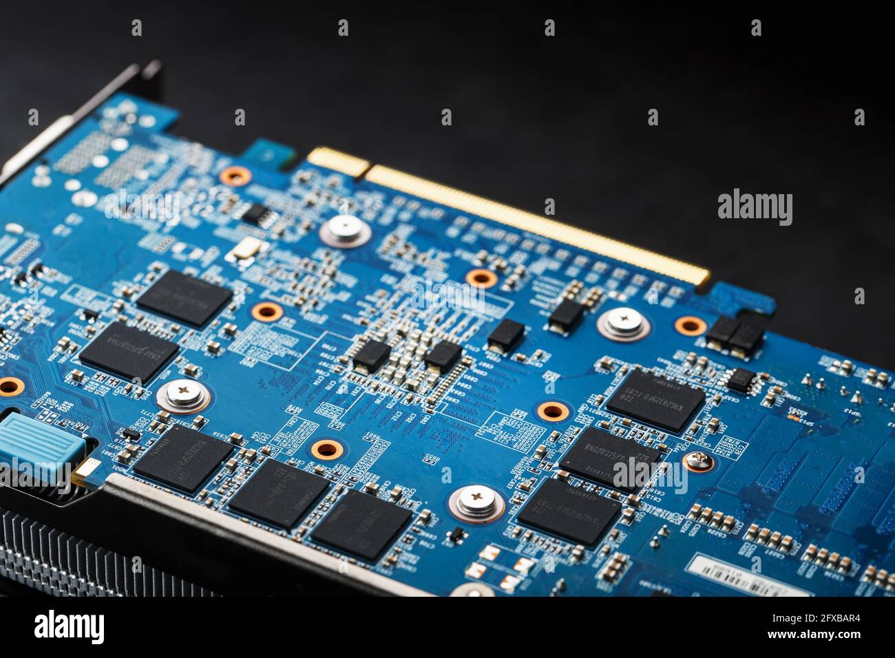 A blue board with chips and a gaming graphics card processor ...
