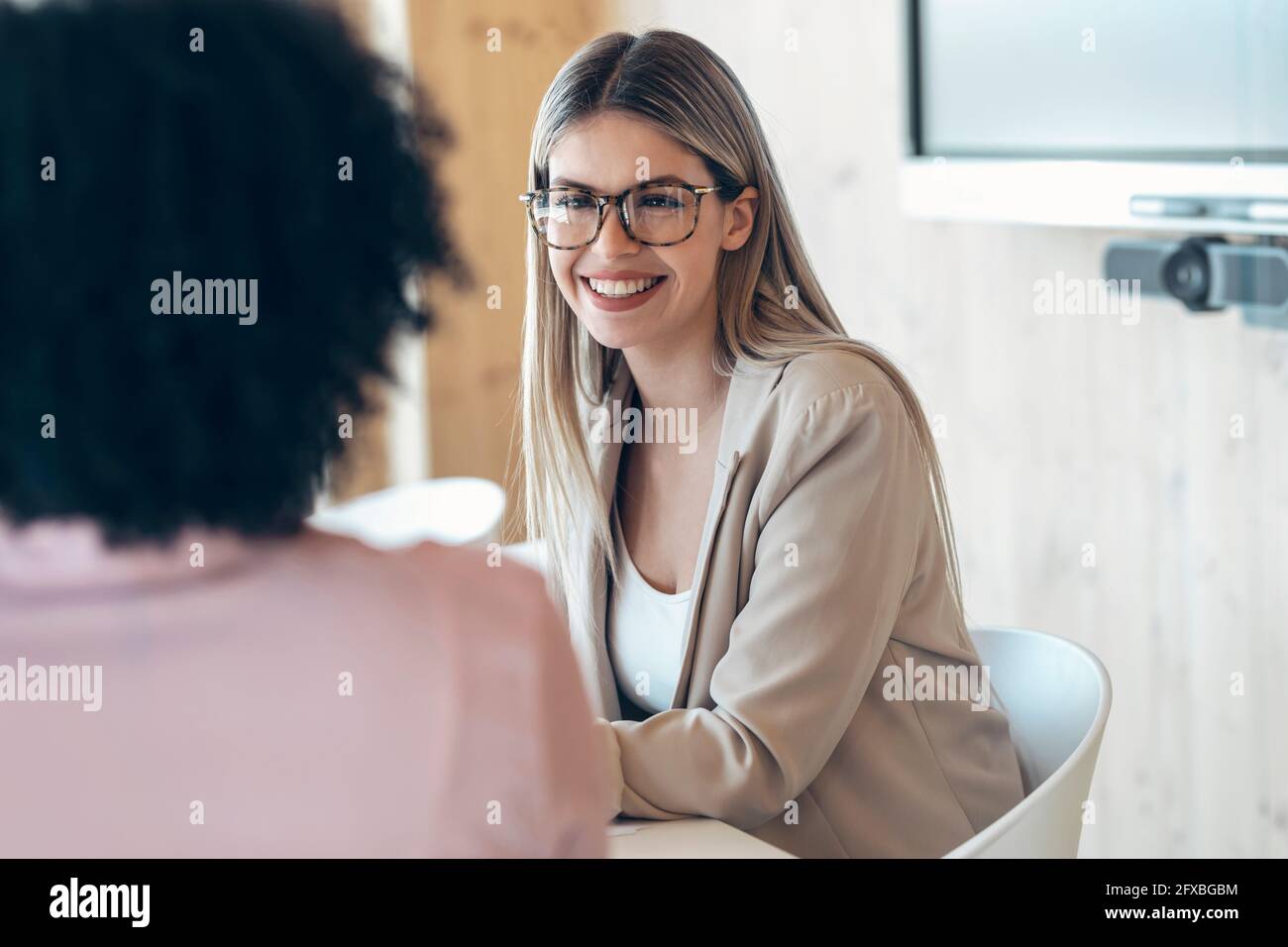 Smiling female professional with coworker in office Stock Photo - Alamy