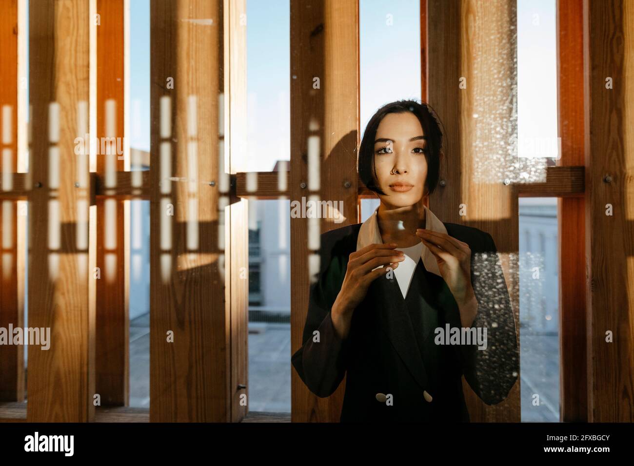 Beautiful woman looking through window Stock Photo - Alamy
