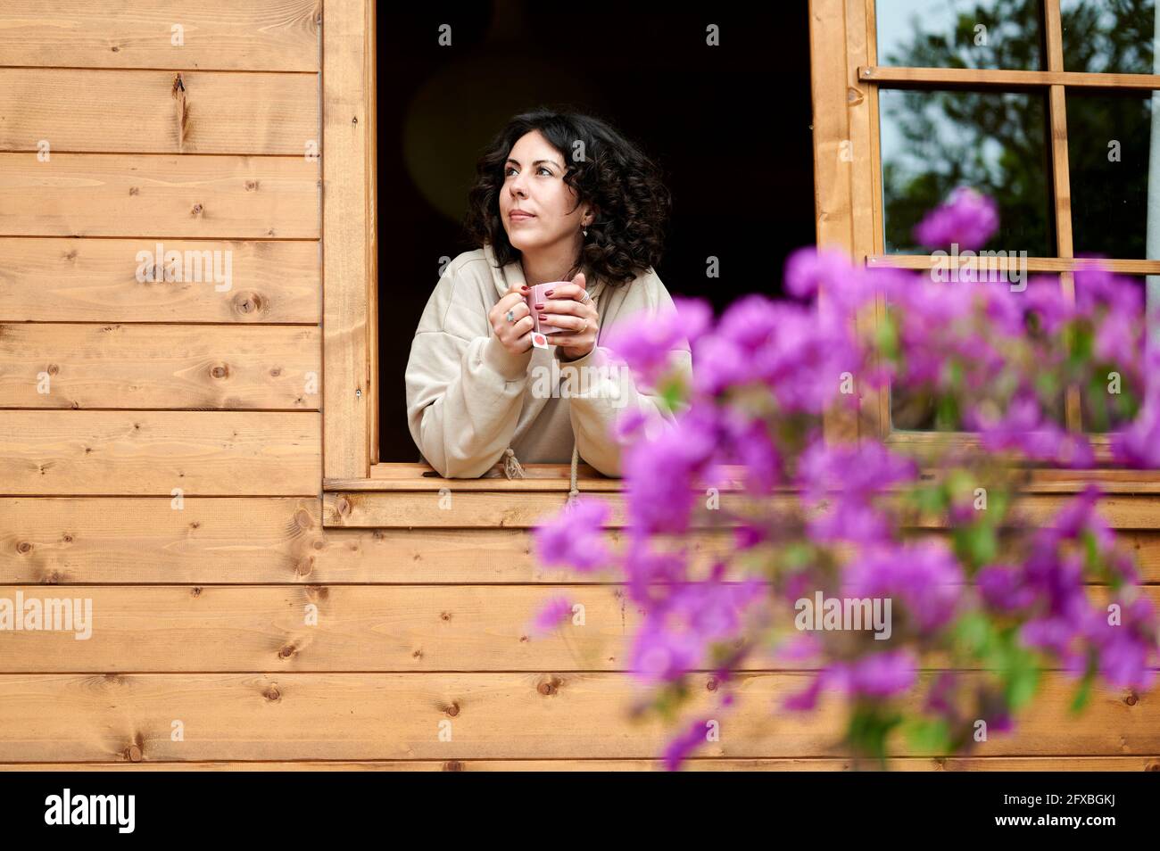 Woman leaning on the window frame hi-res stock photography and images ...