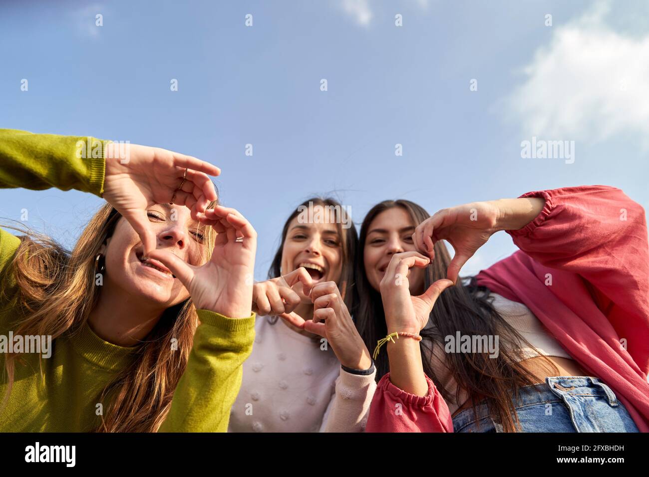 Happy group friends making heart hi-res stock photography and images ...