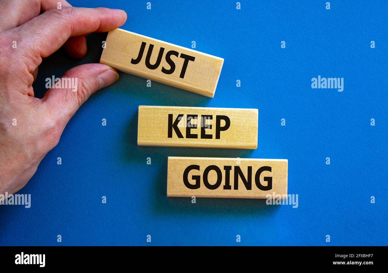Just keep going symbol. Wooden blocks with words 'Just keep going ...