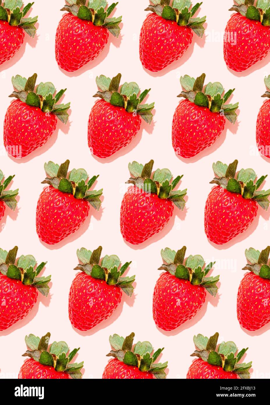 Pattern of fresh ripe strawberries lying againstÂ light pink background ...