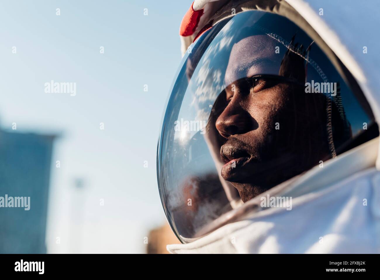 Thoughtful astronaut looking away Stock Photo - Alamy