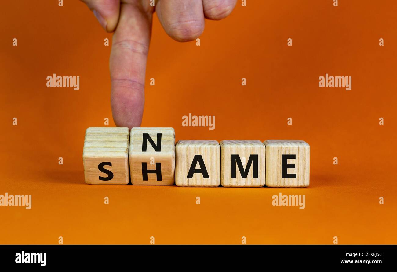 Name or shame symbol. Businessman turns wooden cubes and changes the ...