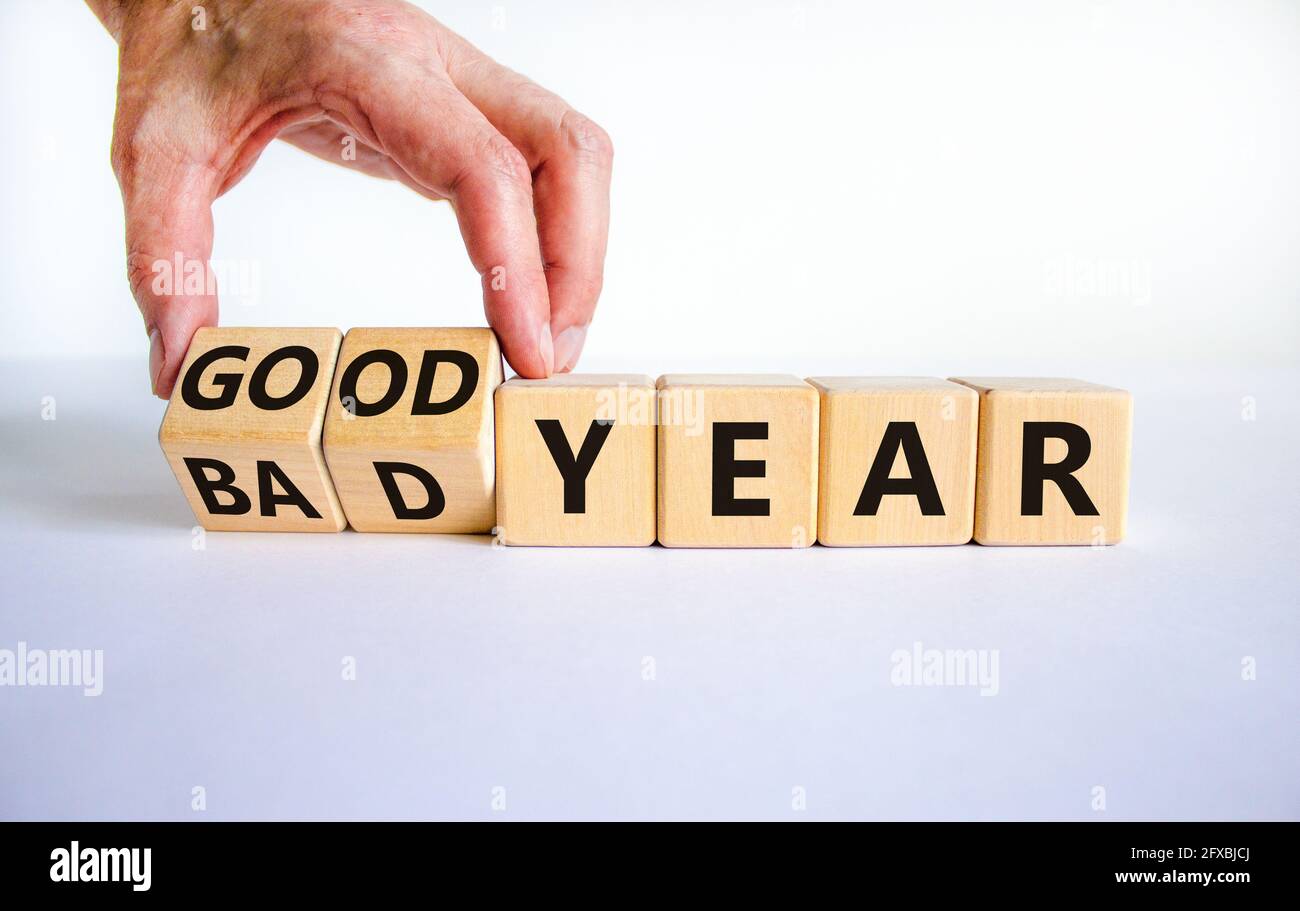 Bad or good year concept. Businessman turns cubes and changes words ...