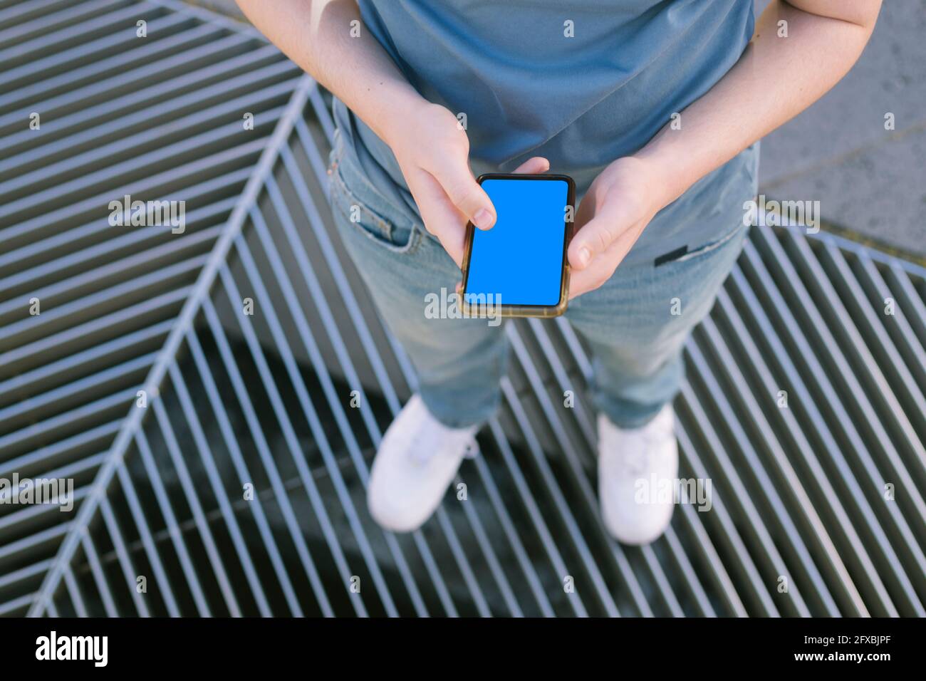 boy's hands holding a cell phone with camera screen Stock Photo - Alamy