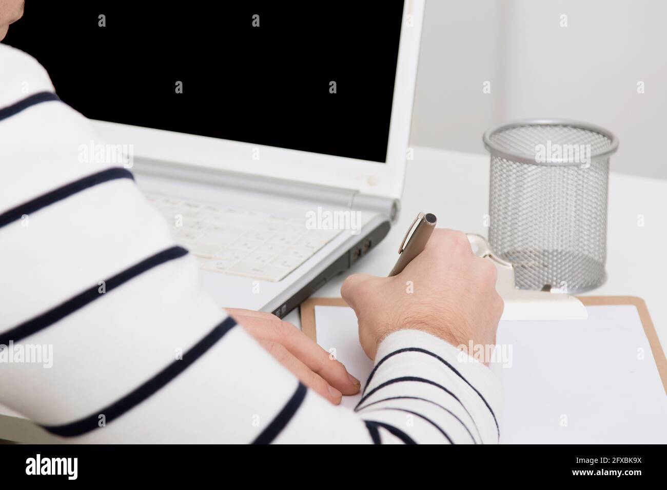 hand with the pen writing on the desk and workspace with computer Stock ...