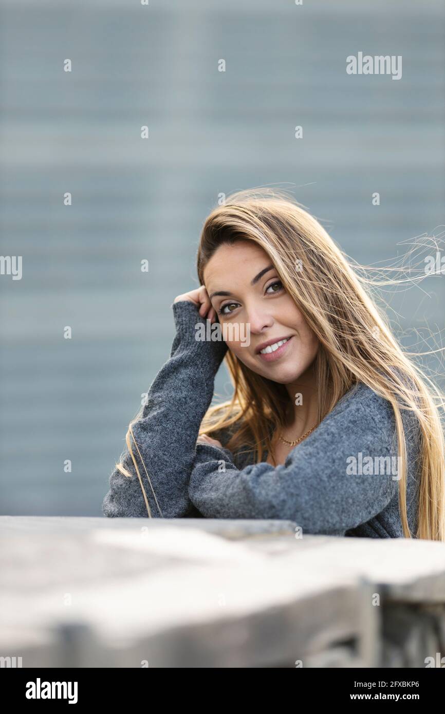 Young woman leaning her head on her hand hi-res stock photography and ...