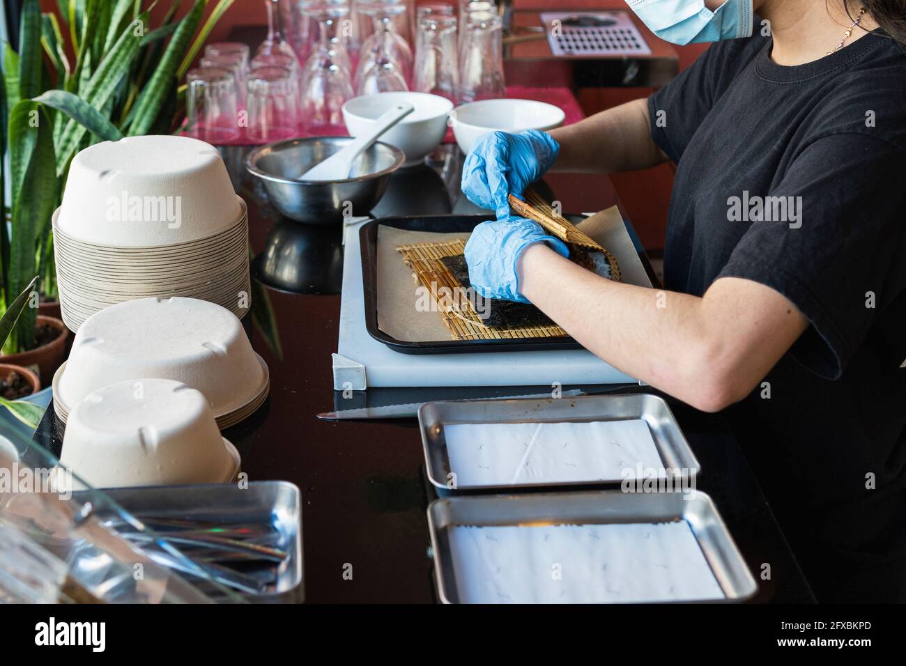 Waitress wrapping food on tray at restaurant during COVID-19 Stock ...