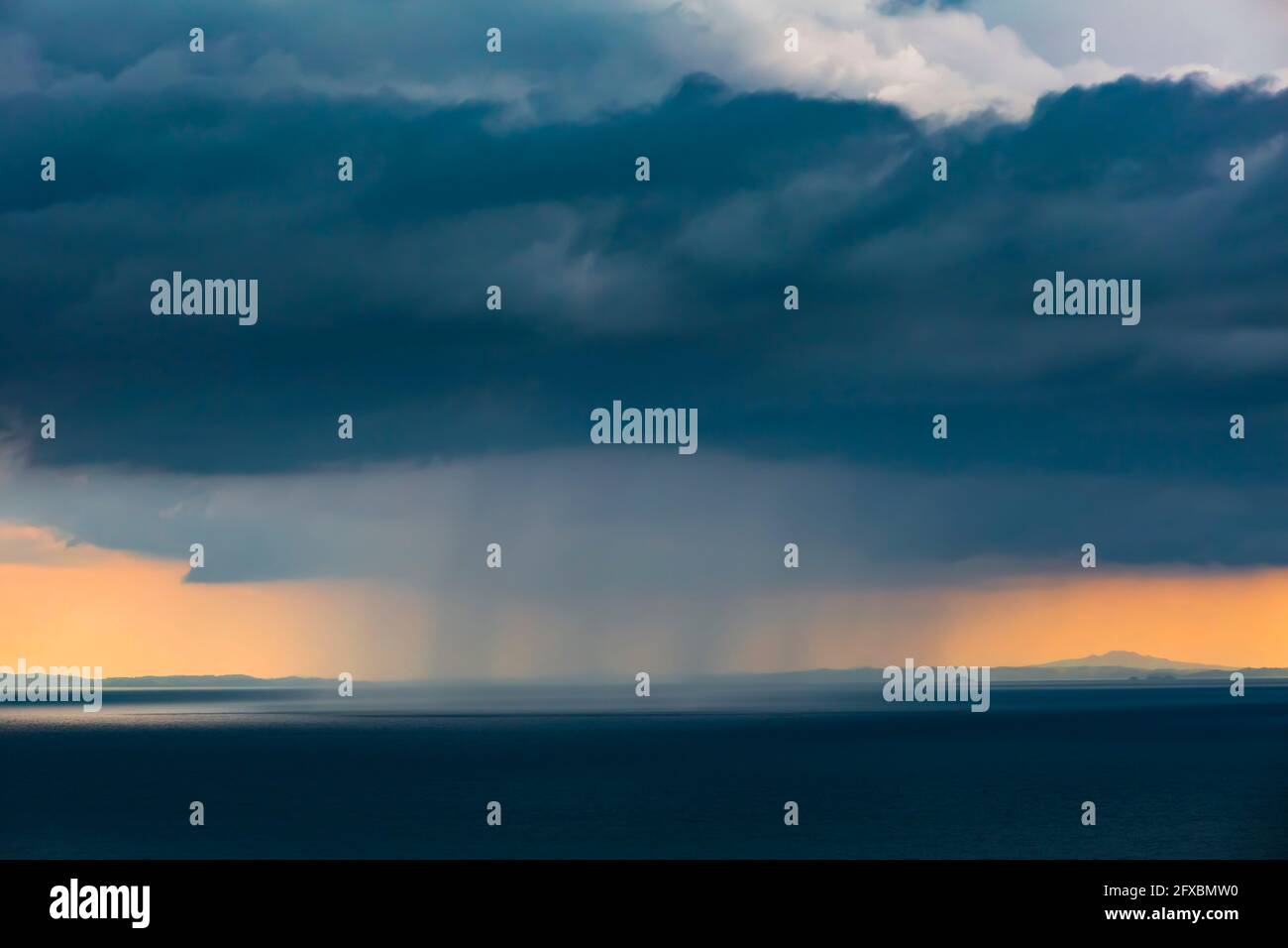 Gray rain clouds over Pacific Ocean at dusk Stock Photo - Alamy