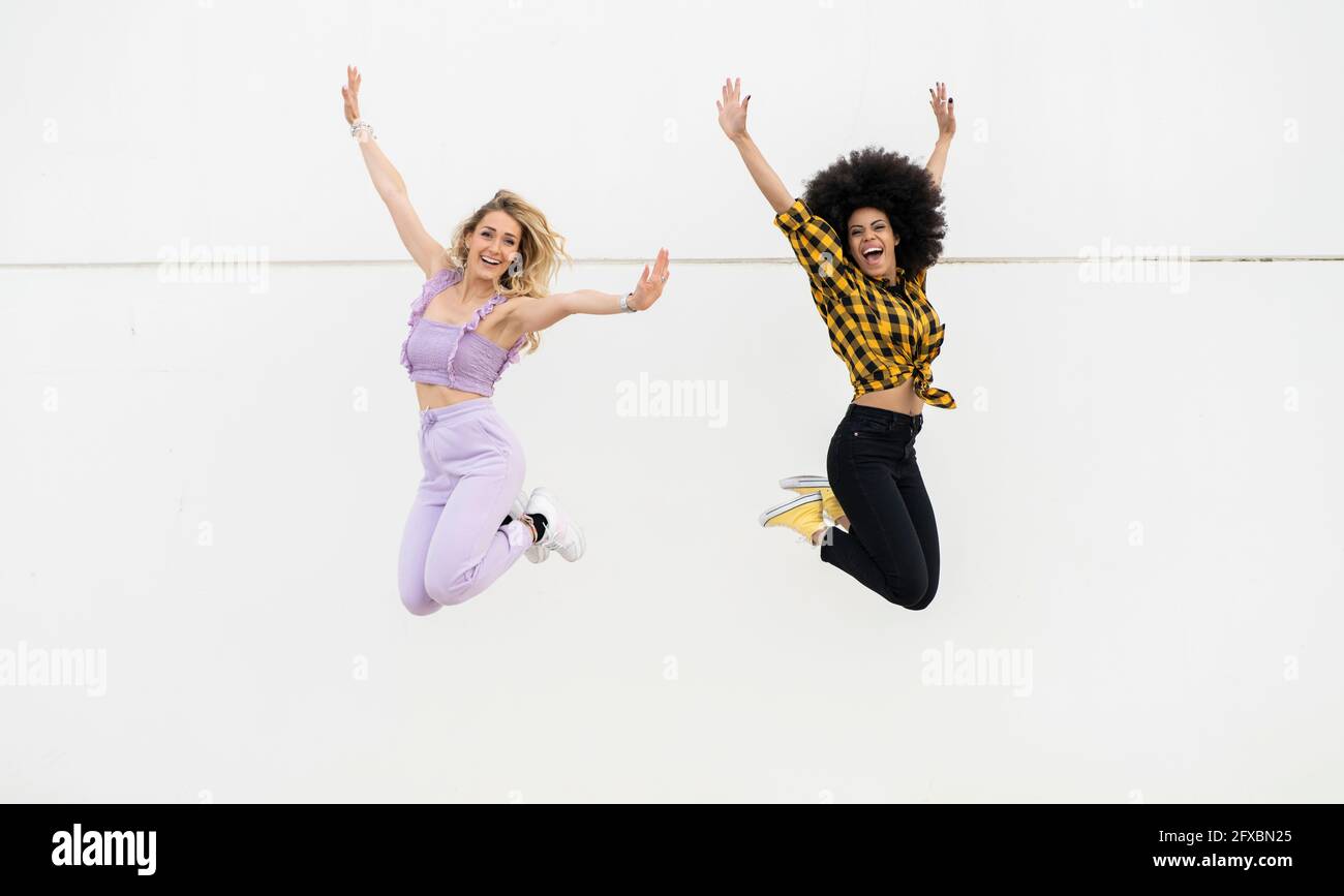 Happy group friends jumping full hi-res stock photography and images ...