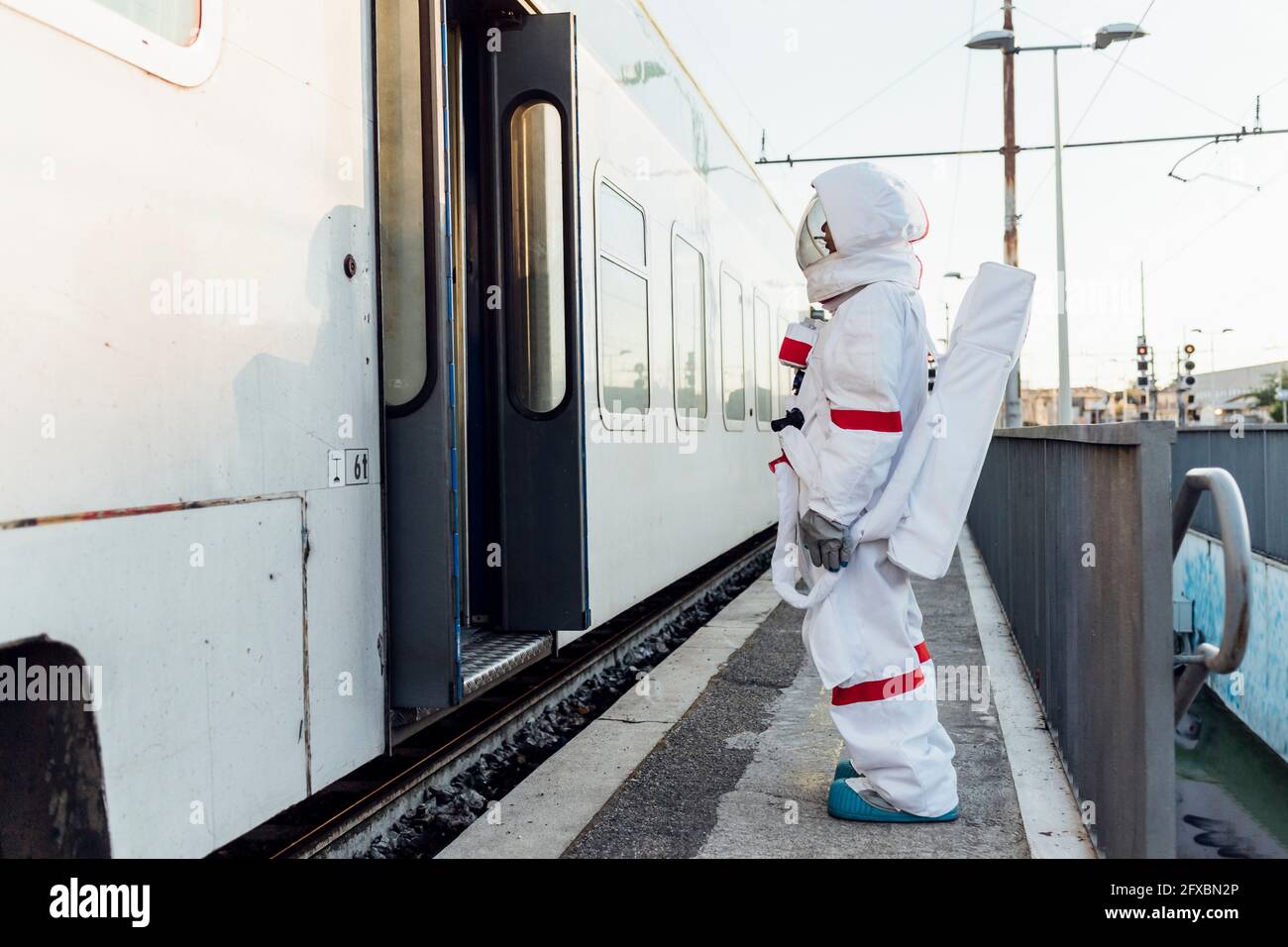 Young female astronaut standing at entrance of train at station Stock ...