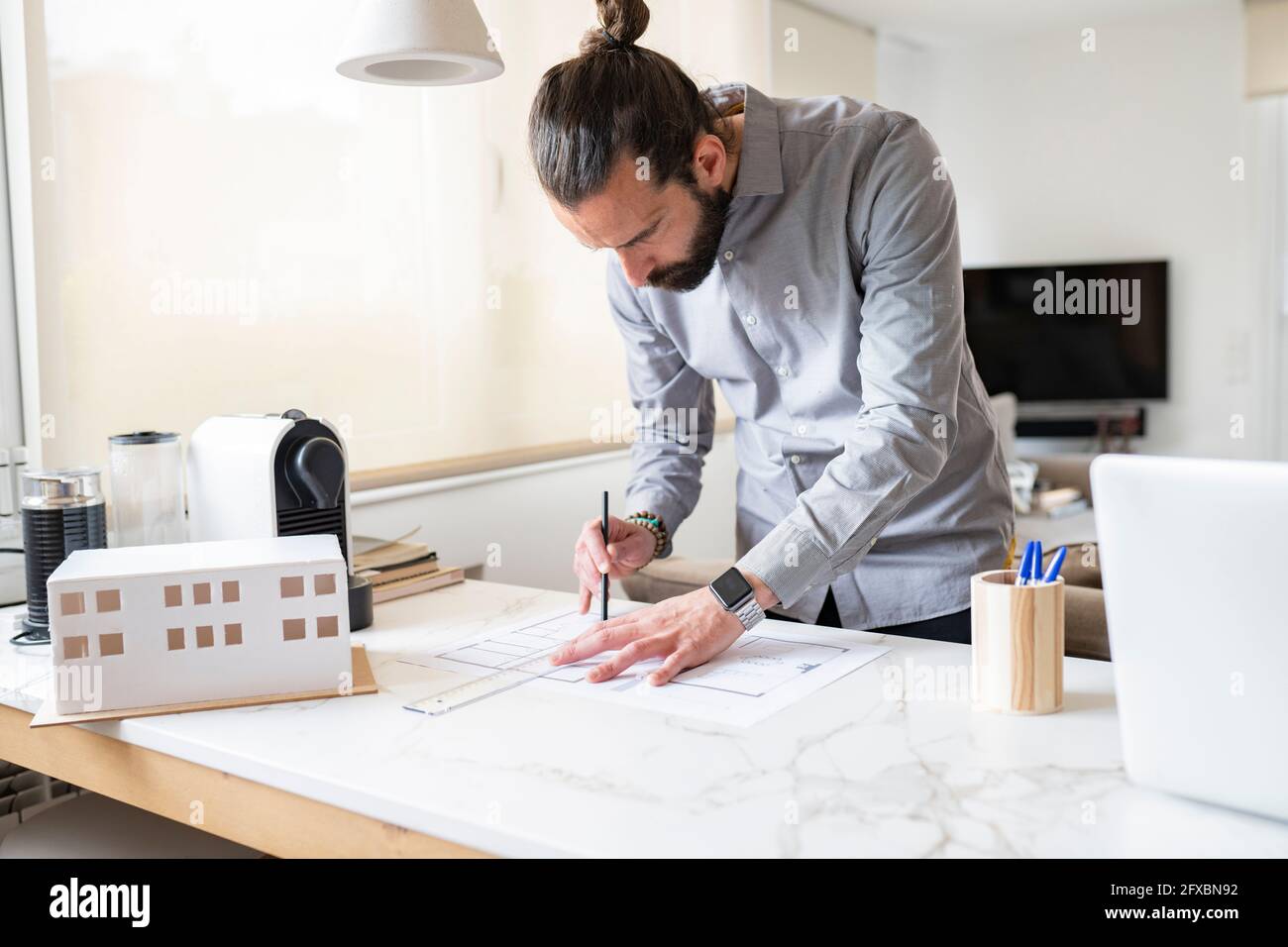 Male architect designing construction plan while working at home Stock ...