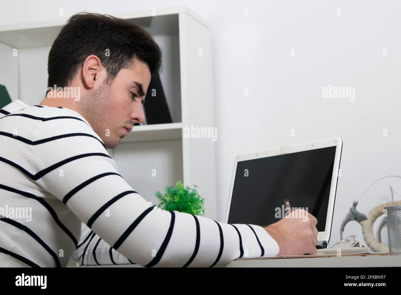 young man studying at home on your desktop with laptop computer Stock ...